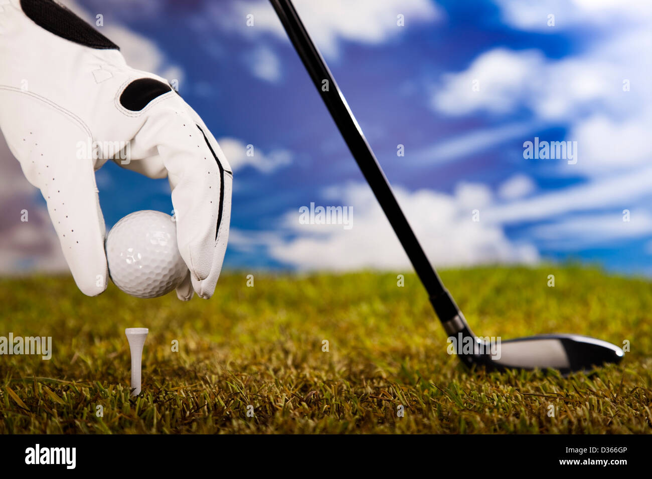 Playing golf, ball on tee Stock Photo - Alamy