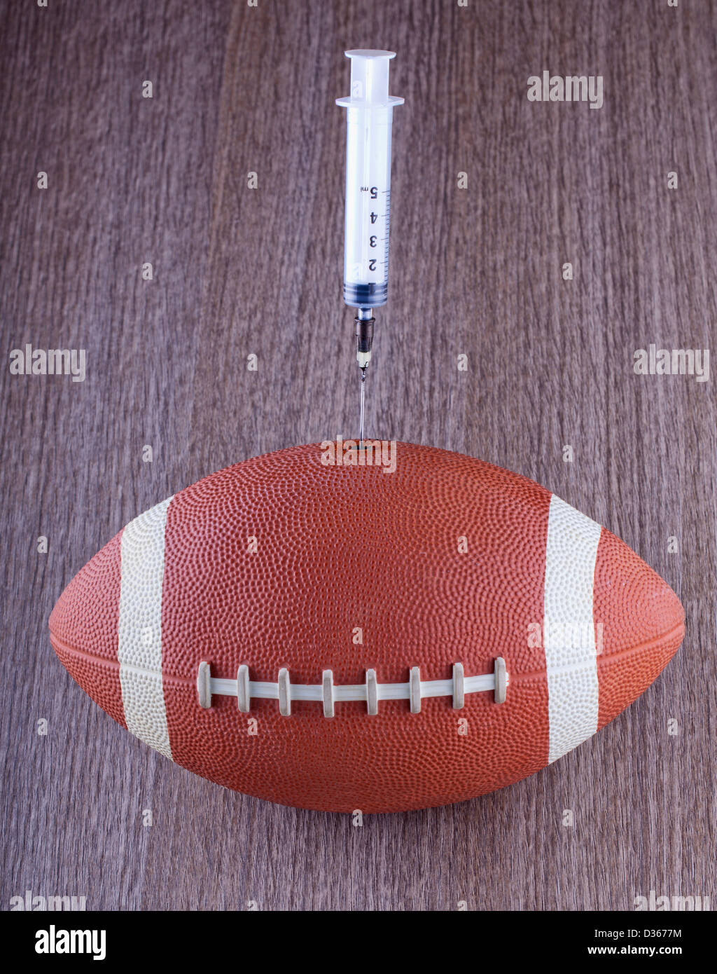 Football syringe injecting over wooden hi-res stock photography and ...