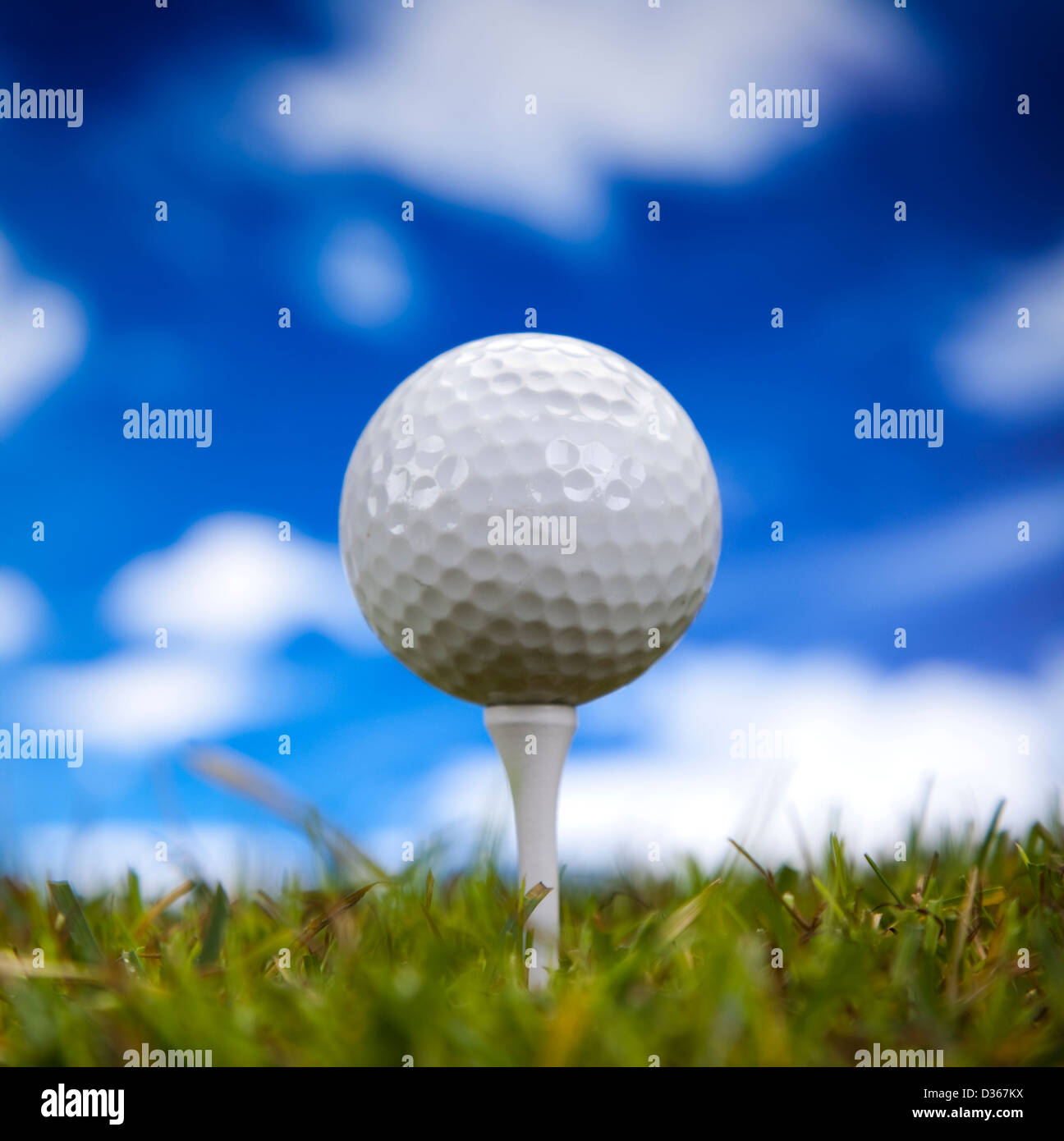 Playing golf, ball on tee Stock Photo - Alamy
