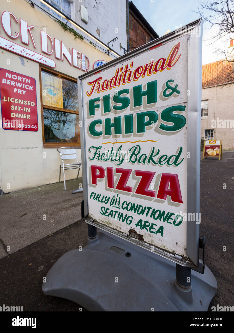 A sign advertising a traditional fish and chip shop in the coastal town ...