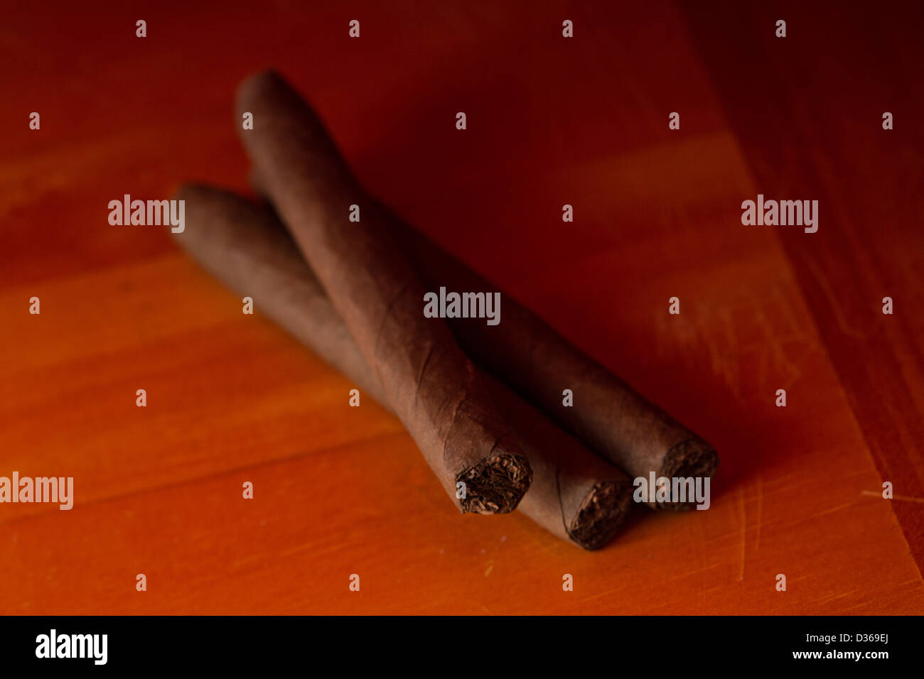 Three cigars on a table Stock Photo - Alamy