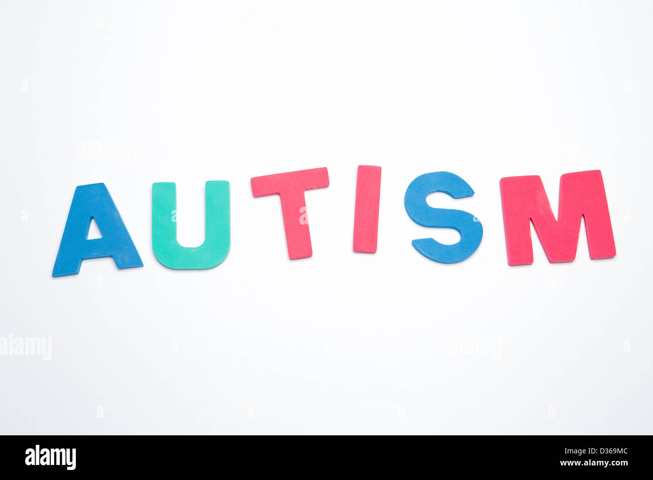 Autism spelled out in pink green and blue Stock Photo - Alamy