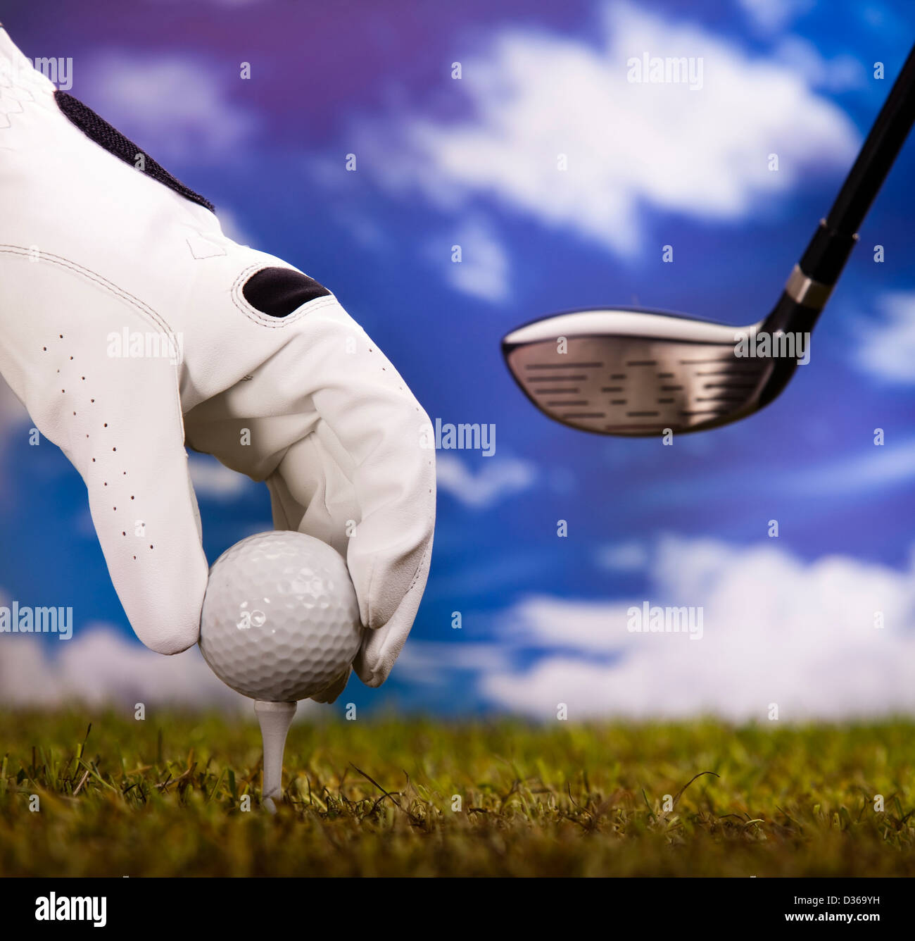 Playing golf, ball on tee Stock Photo - Alamy