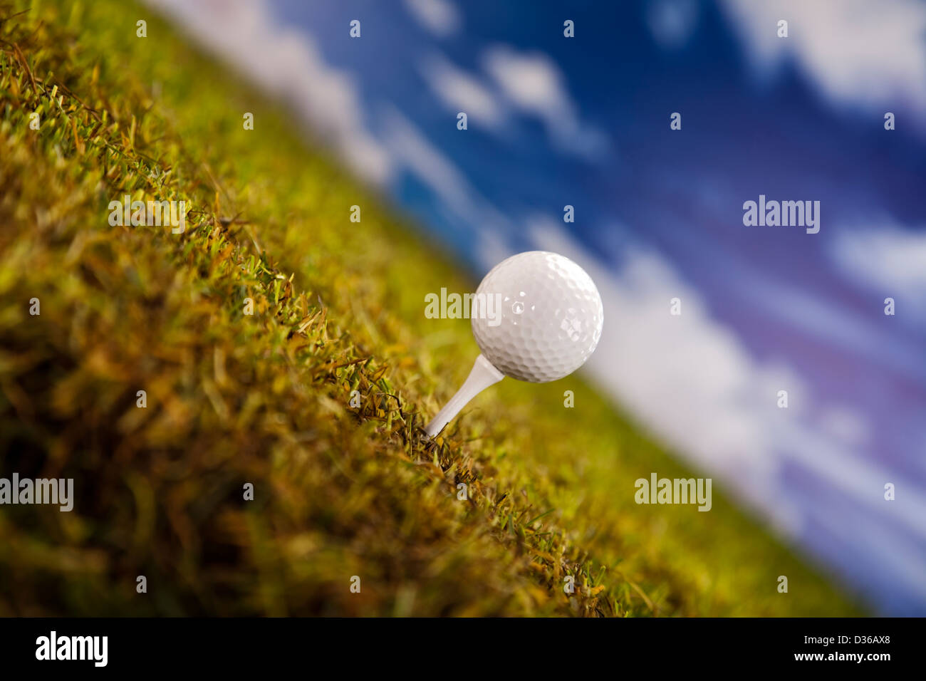 Golf ball on tee Stock Photo - Alamy