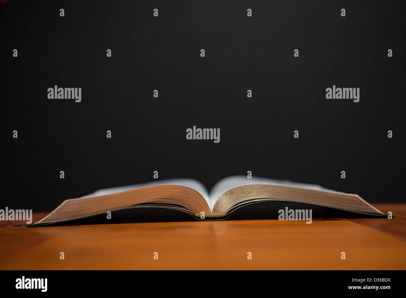 Open book on a table Stock Photo - Alamy