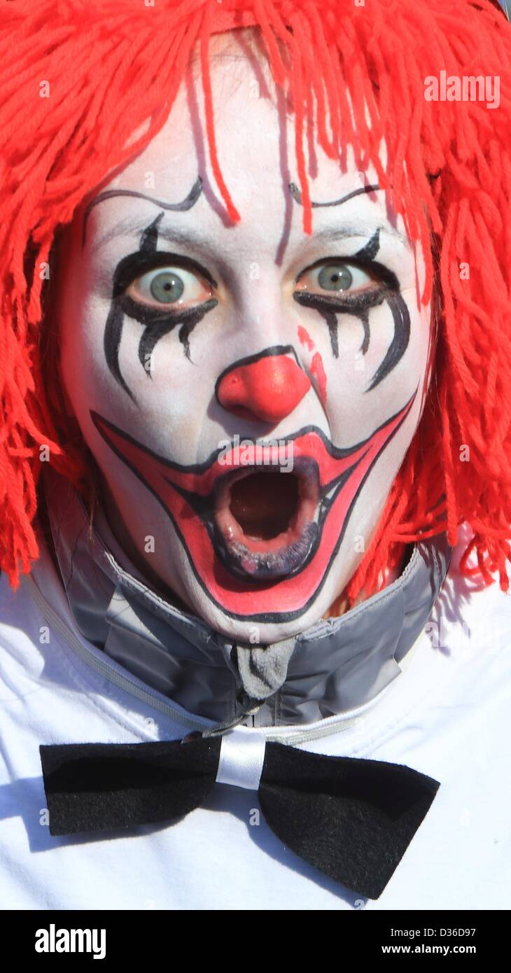 A woman dressed as a cloun takes part in the carnival parade in Koethen ...