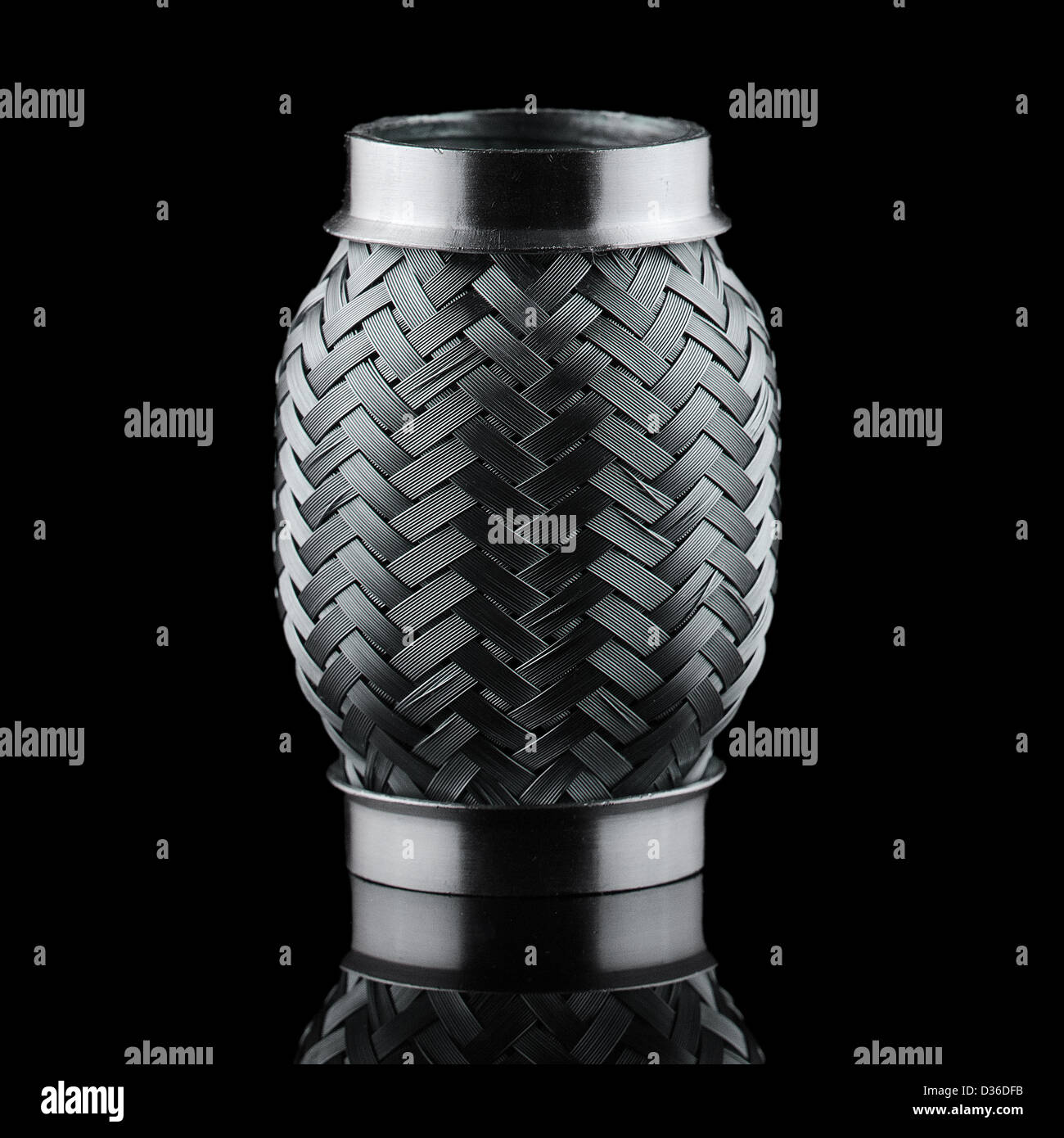 Flexible tube connection to the car exhaust system on black background ...