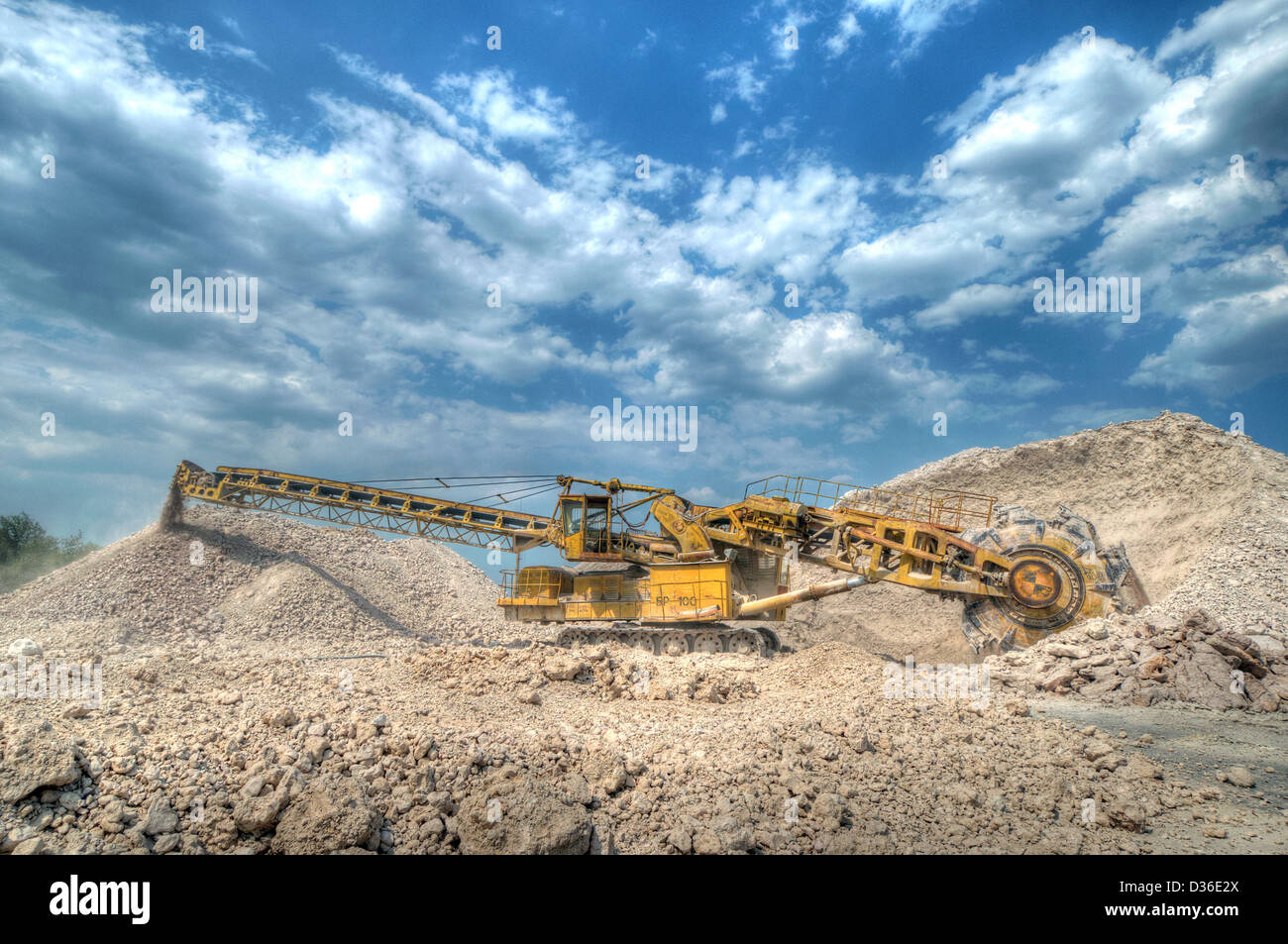 A construction vehicle loading clay onto a cargo truck Stock Photo - Alamy