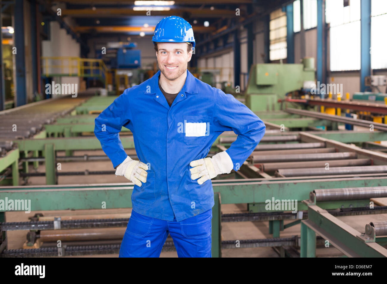 Construction worker with helmet in assembly hall Stock Photo - Alamy