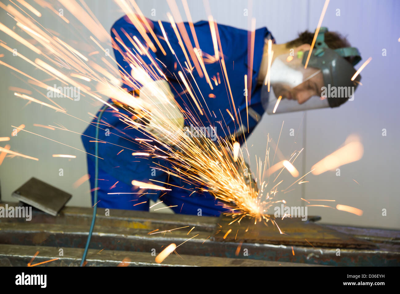 Worker using angle grinder factory hi-res stock photography and images ...
