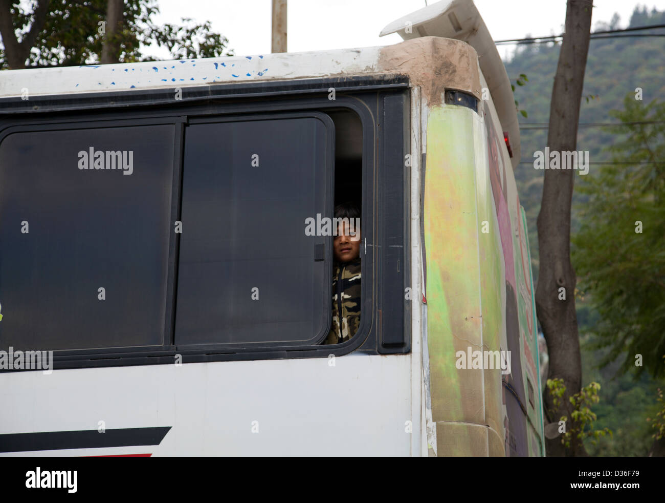 Boy peering out bus in Oaxaca - Mexico Stock Photo - Alamy