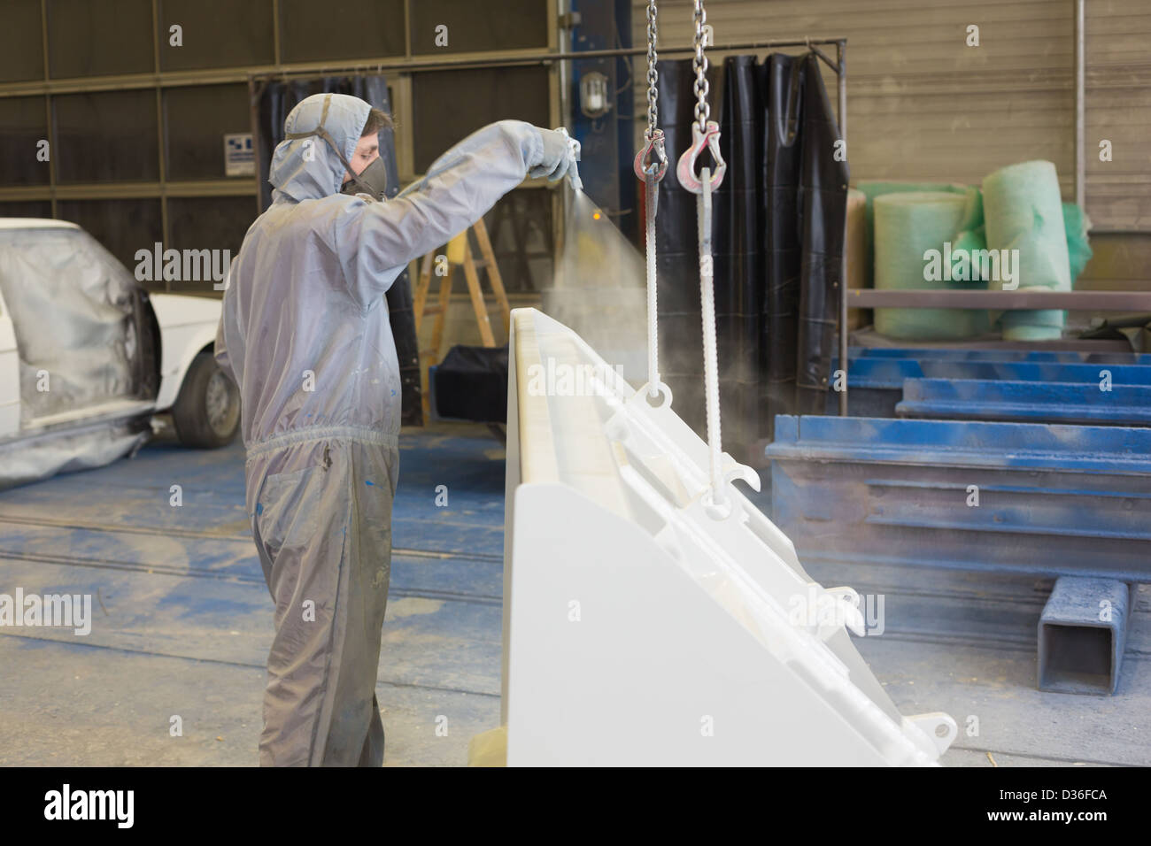 vehicle painter spraying white color on construction bucket Stock Photo ...