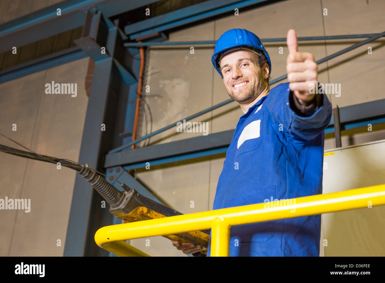 Construction worker operating a crane with a remote control Stock Photo ...