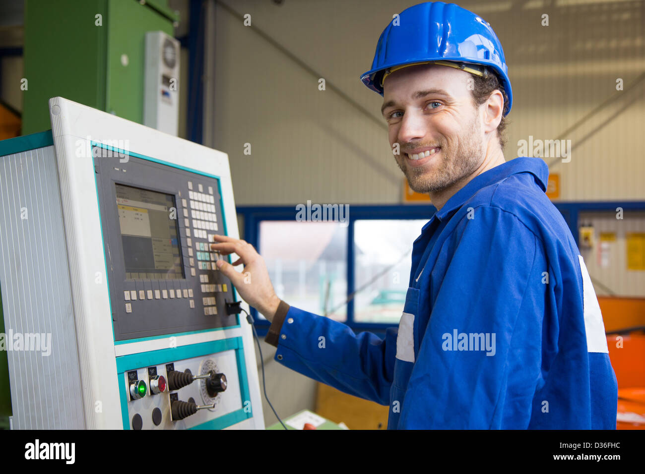 Factory worker operating industrial machine hi-res stock photography ...