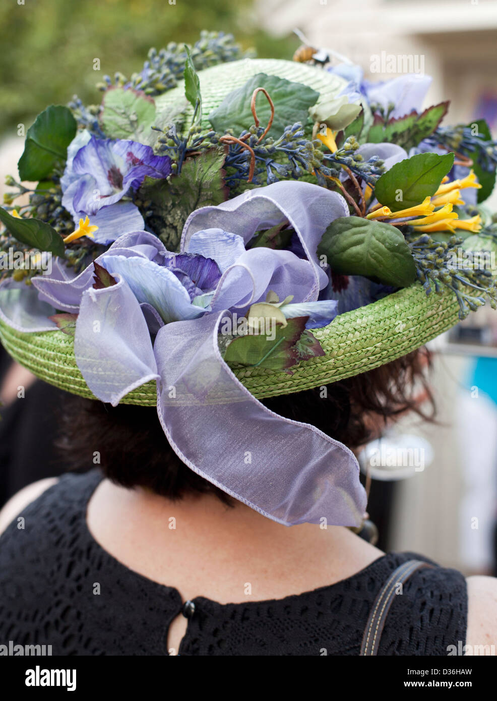 A woman wears a flowered hat at an outdoor party Stock Photo - Alamy