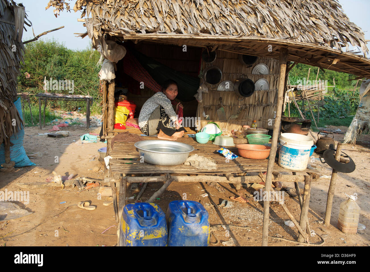 looking on from her bamboo shack Stock Photo - Alamy