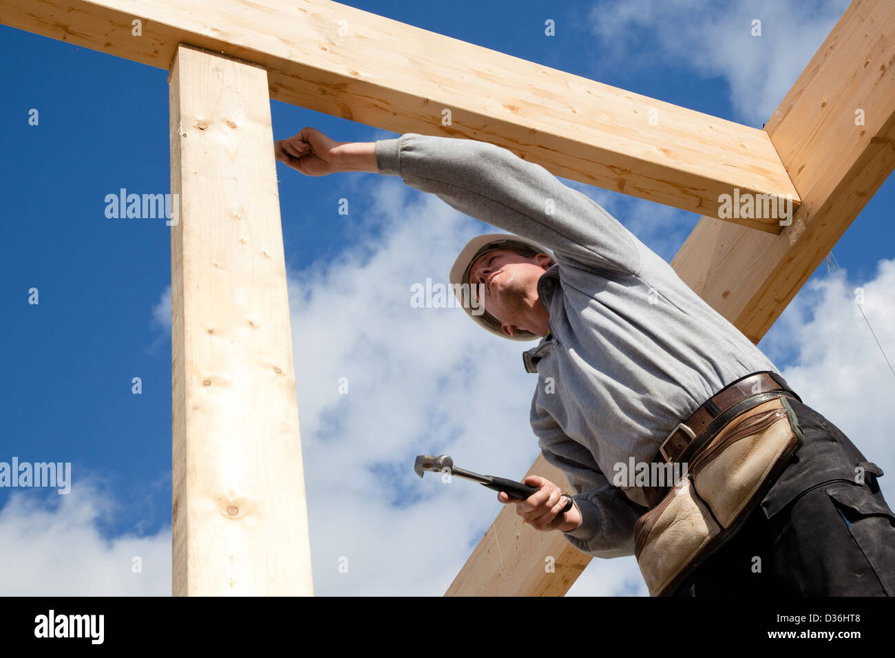 real builder at work on construction site. making a roof Stock Photo ...