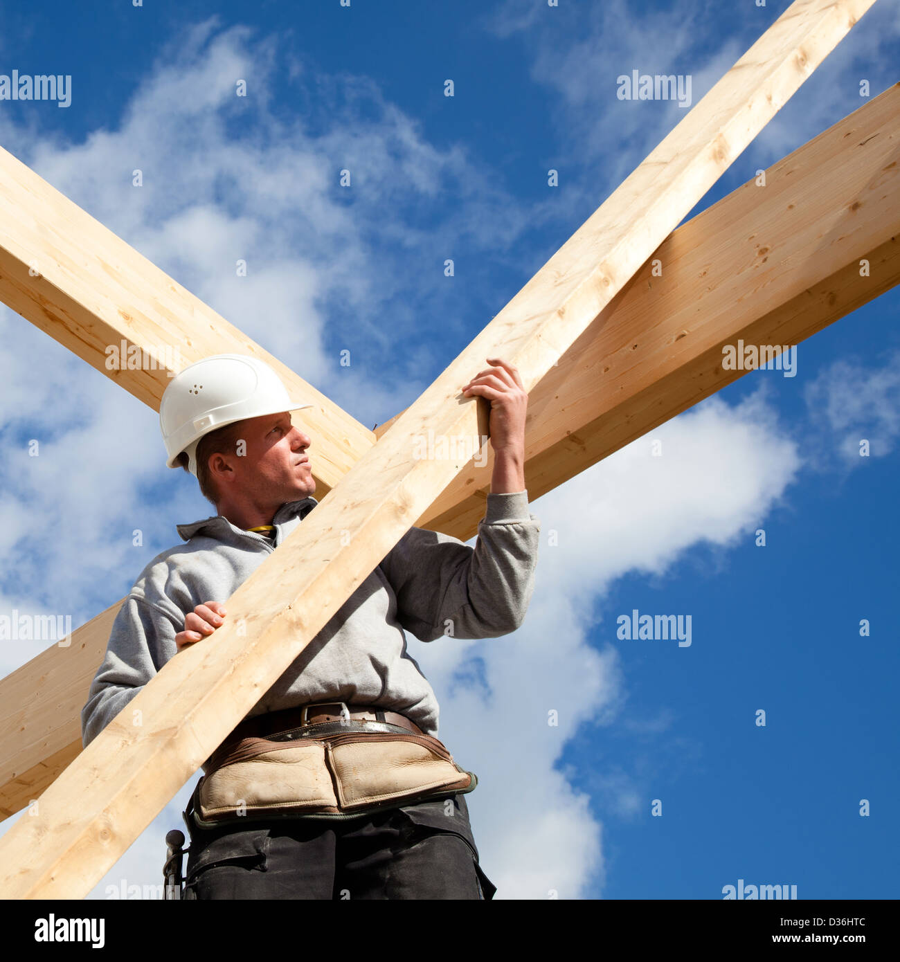 real builder at work on construction site. making a roof Stock Photo ...