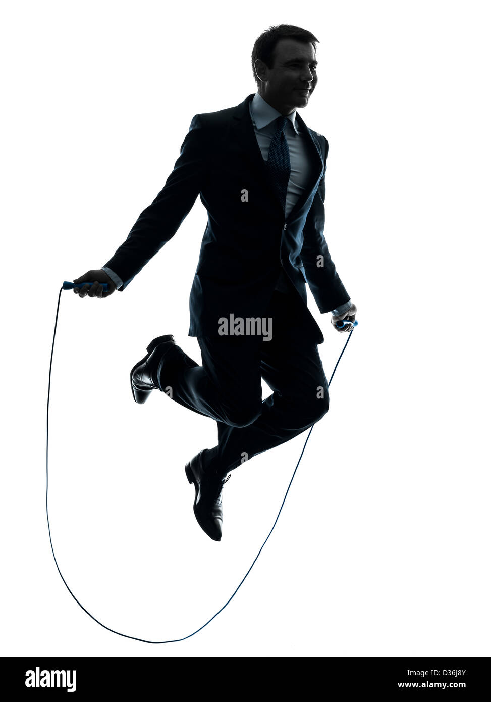 one businessman exercising jumping rope in silhouette studio isolated ...