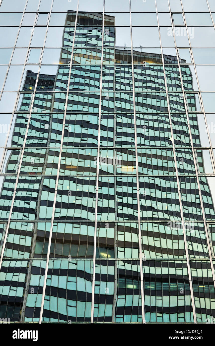 Glass fronted HM Revenue & Customs office building reflected in a glass ...