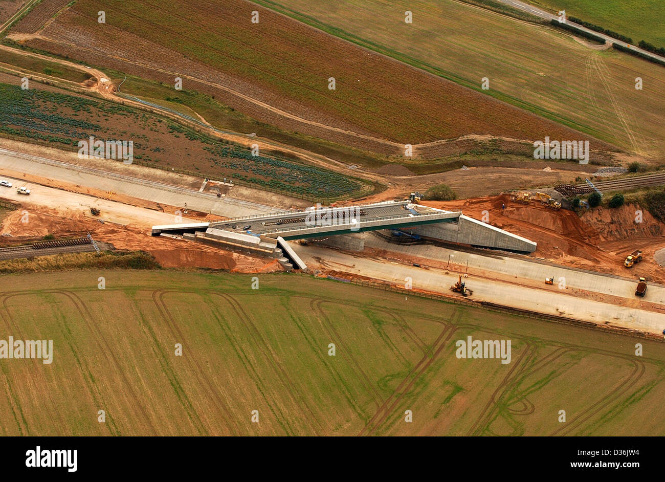 M6 Toll motorway under construction with railway bridge near Hammerwich ...