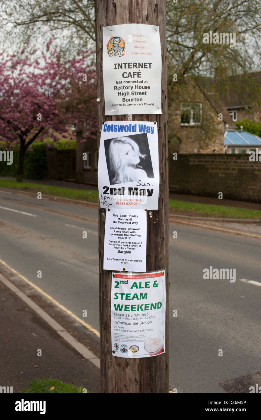 Flyposting Signs adverts on telegraph pole BT UK Stock Photo - Alamy