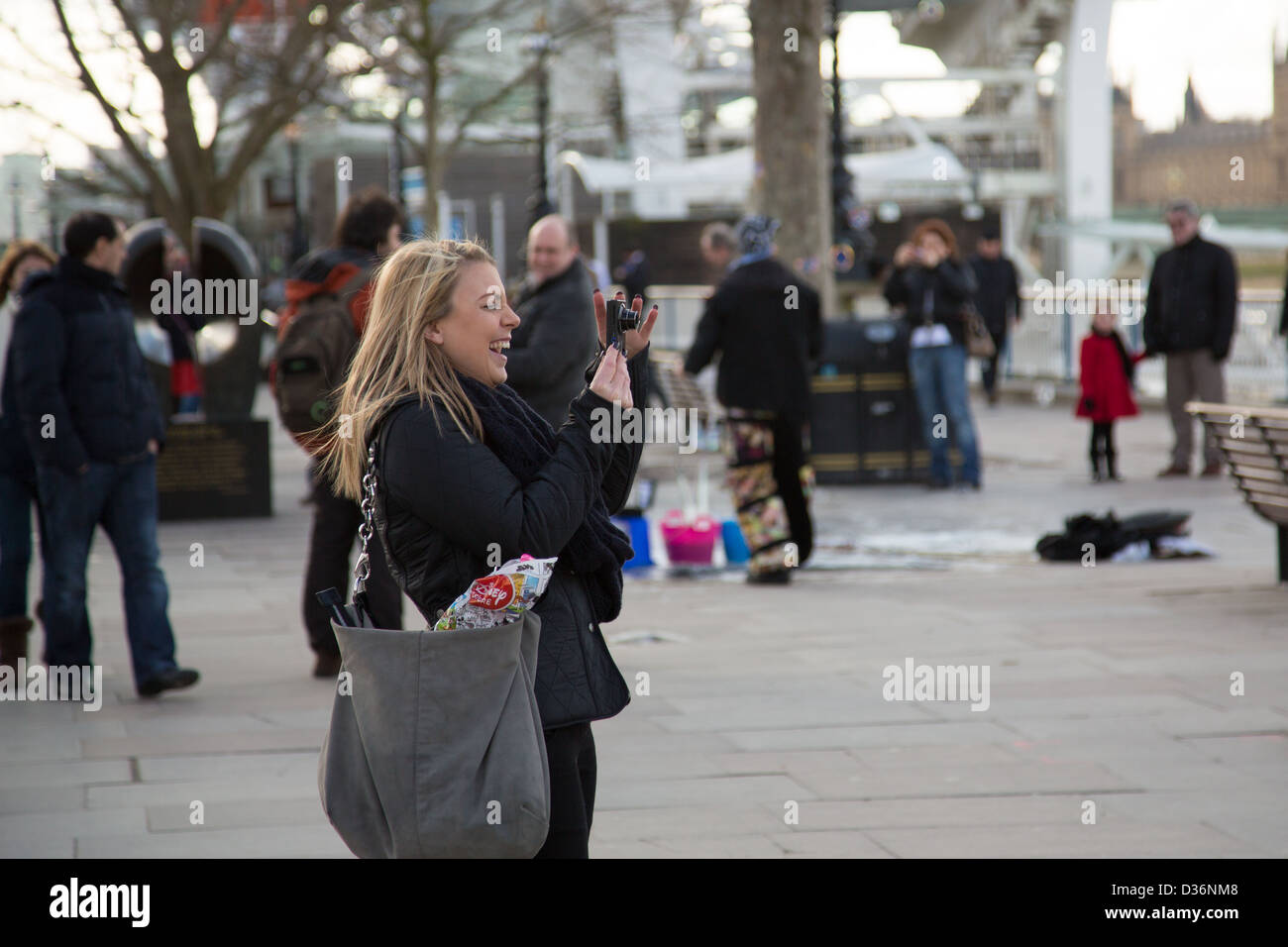 Tourist enjoying the street performance along The Southbank, London ...
