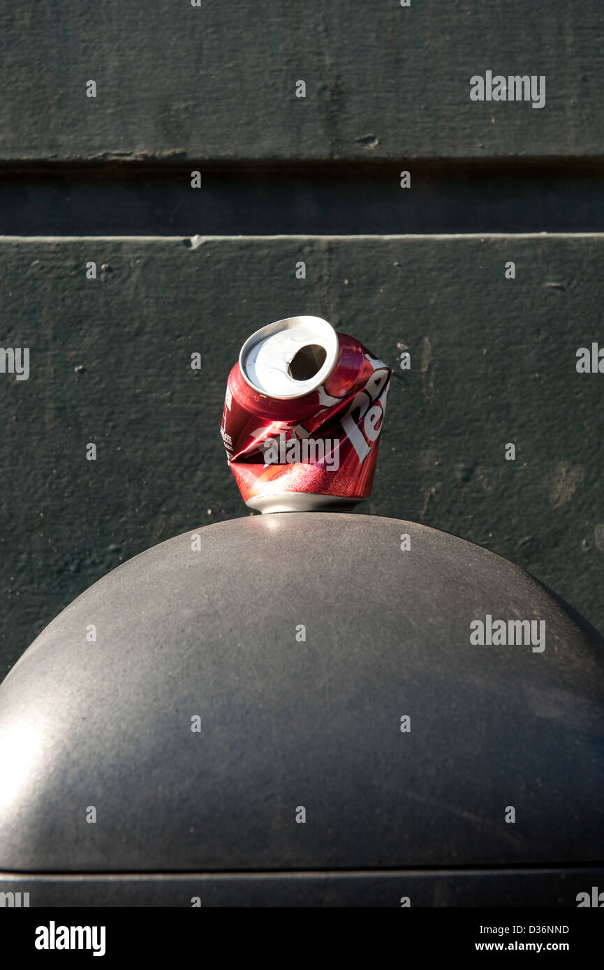 Crushed soft drink can on top of waste bin Stock Photo - Alamy