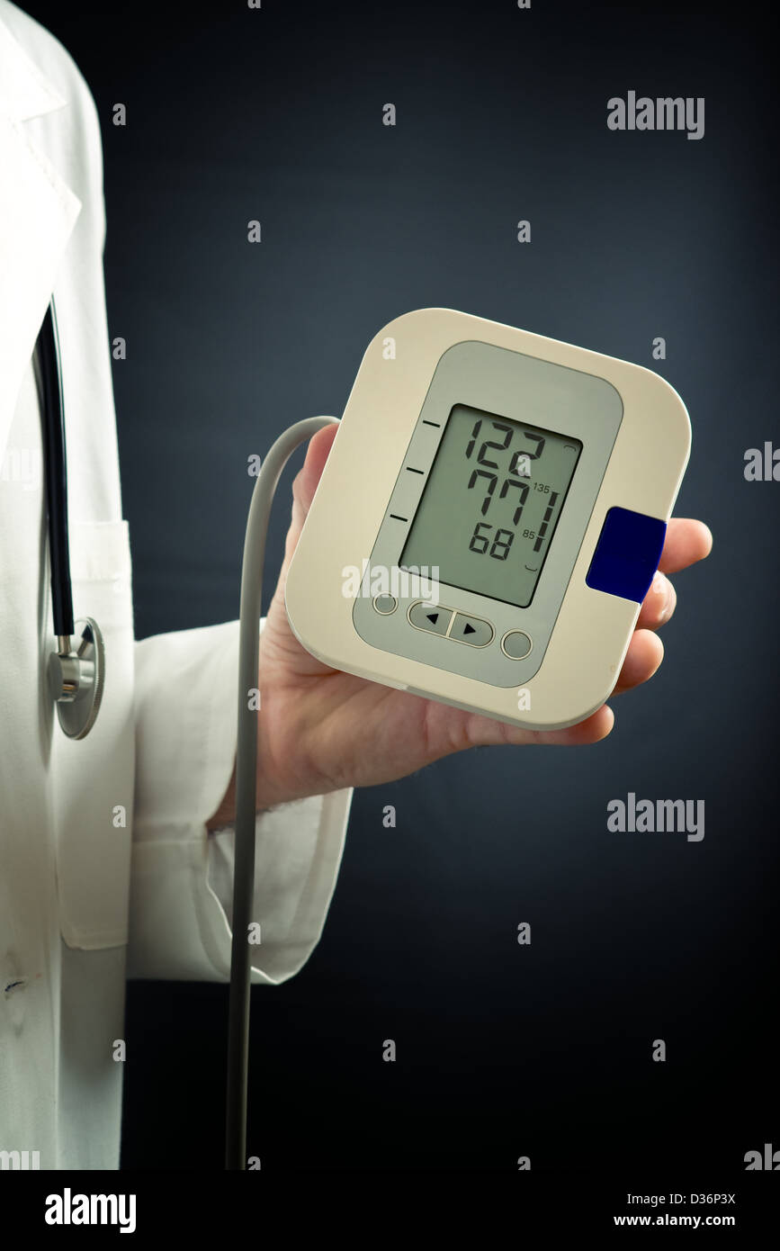 Doctor holding a digital blood pressure instrument Stock Photo - Alamy