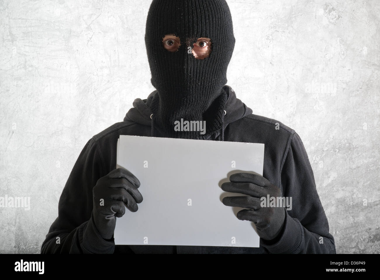 Arrested burglar concept, thief with balaclava caught and arrested in ...