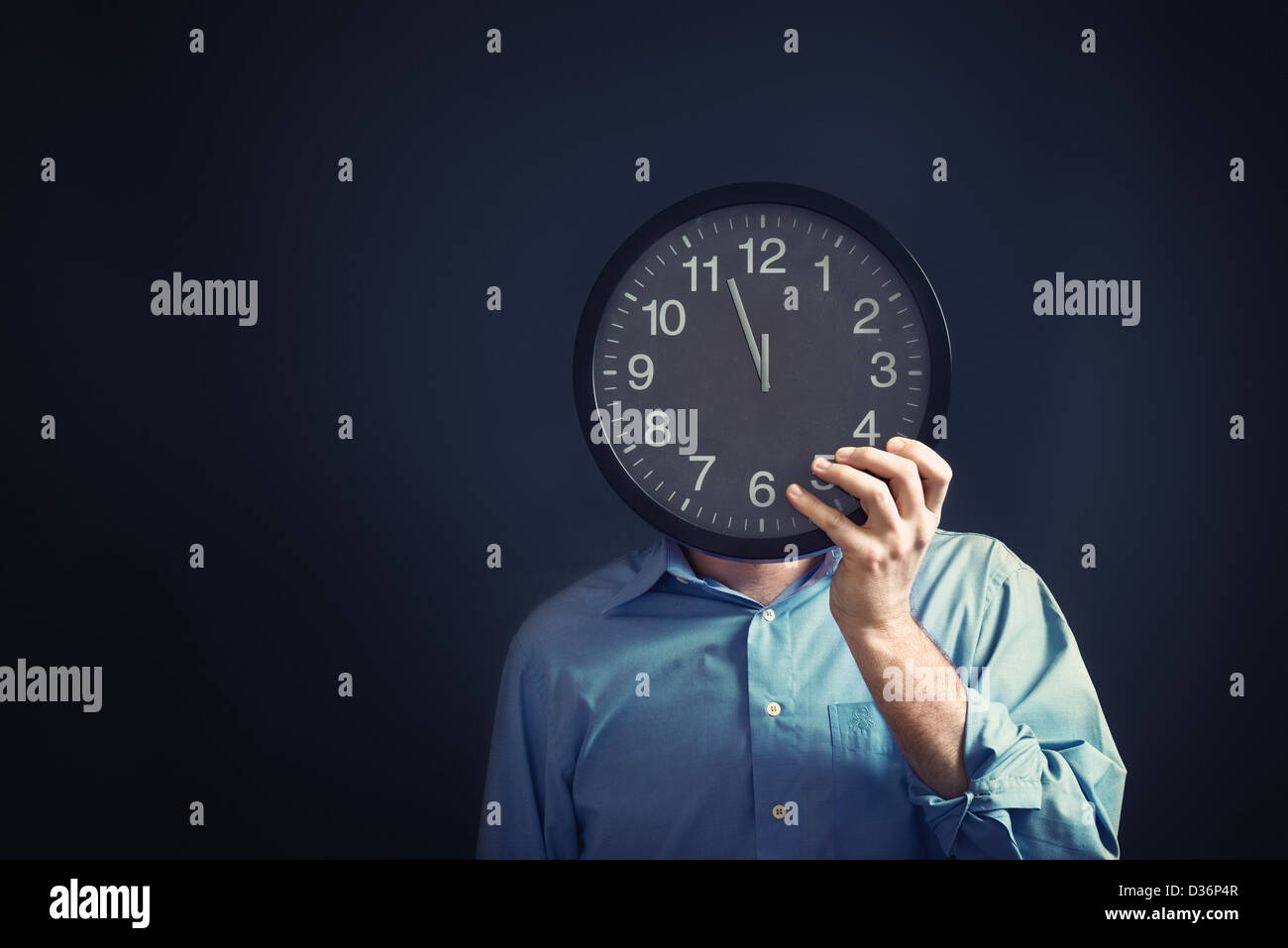 Businessman with black clock in front of his head, deadline concept ...