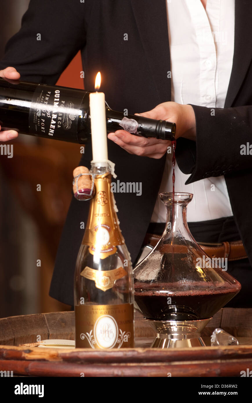 Waiter pouring Red Wine Decanter bottle candle posh Stock Photo - Alamy