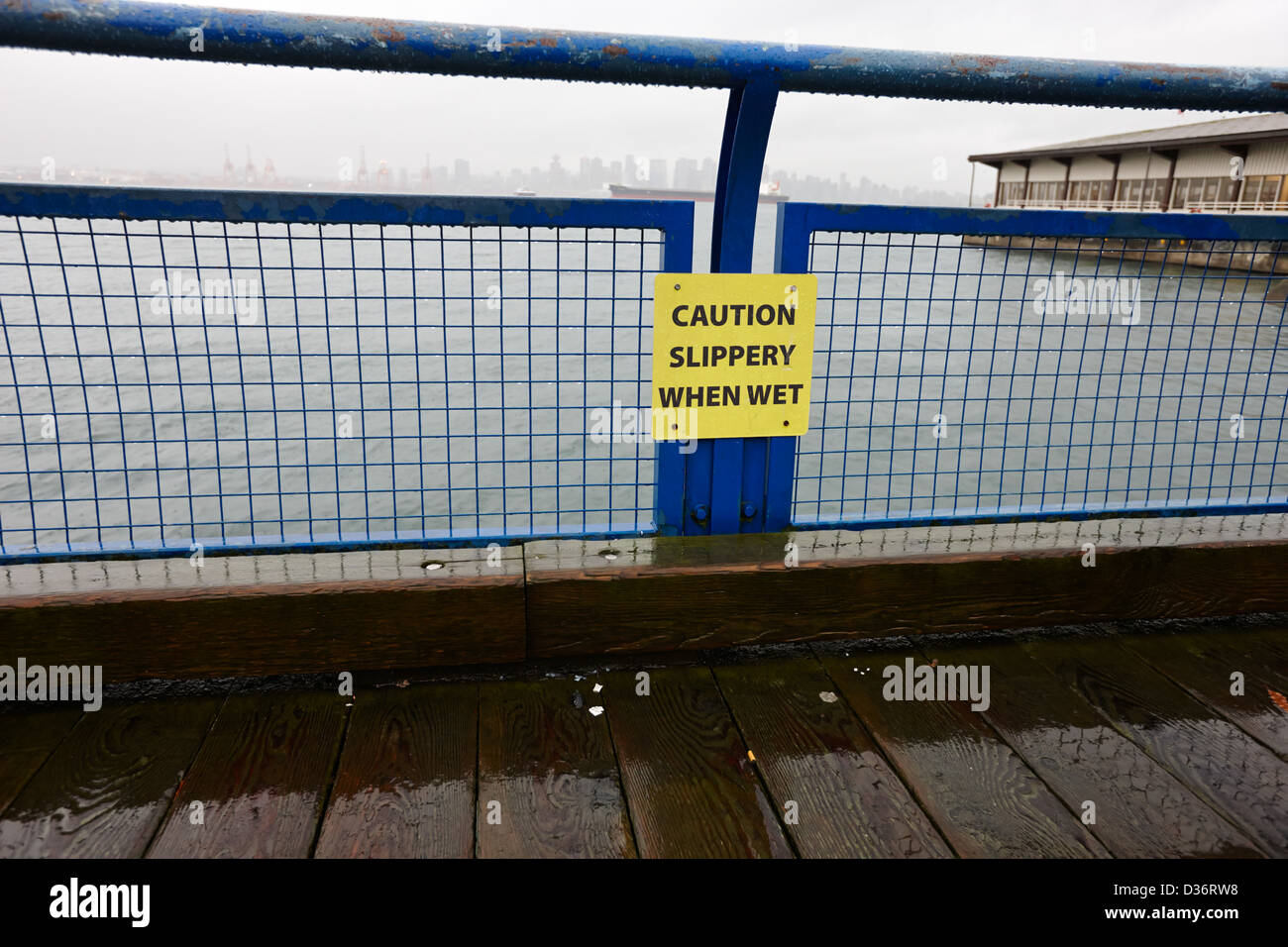 caution slippery when wet sign on wooden seafront walkway north ...