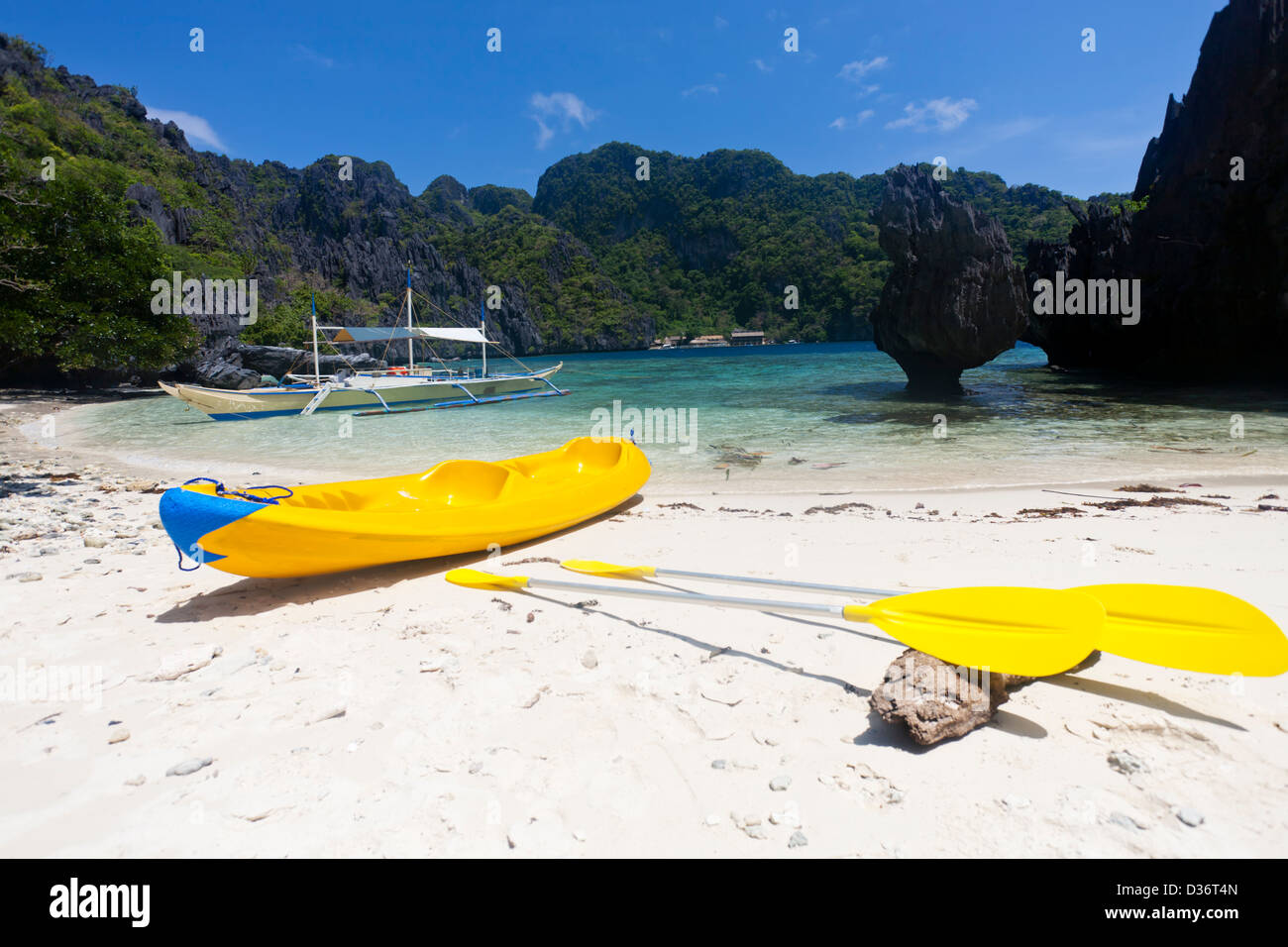 Yellow canoe on the beach Stock Photo - Alamy