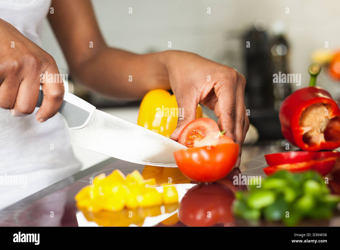 African American womans hand slicing a tomatoe Stock Photo - Alamy