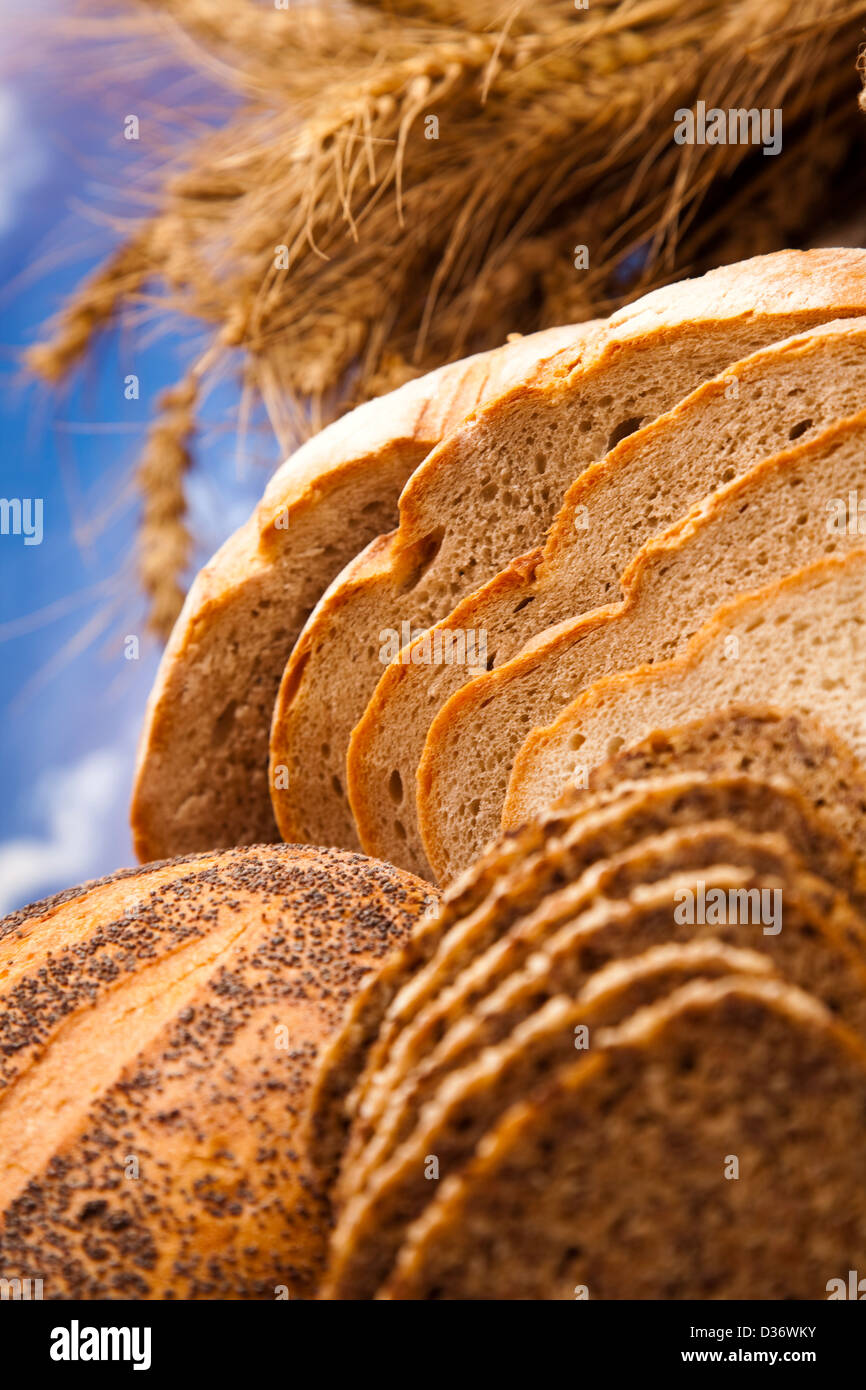 Assortment of baked bread on blue sky background Stock Photo - Alamy