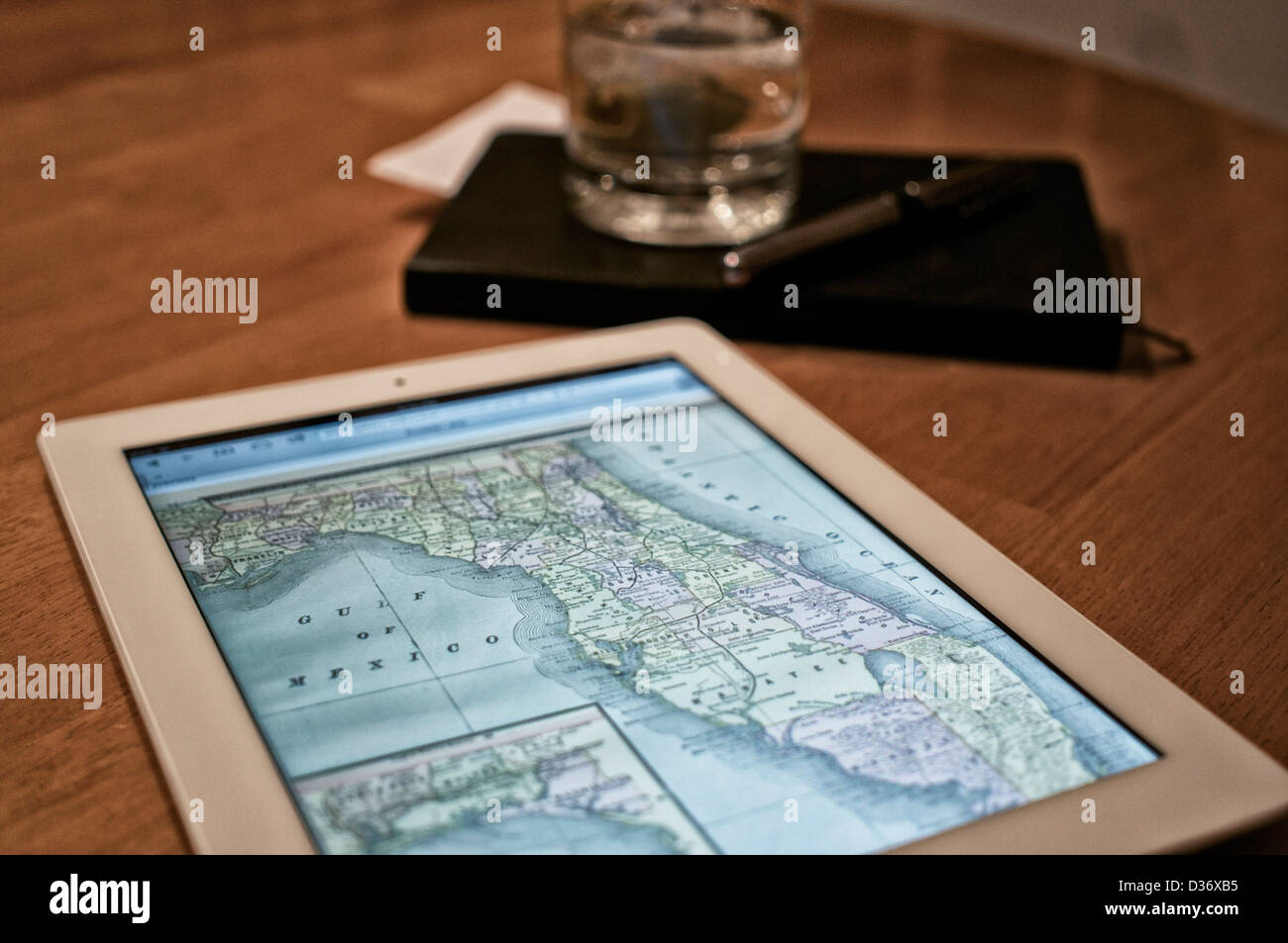 iPad on table with antique map displayed Stock Photo - Alamy