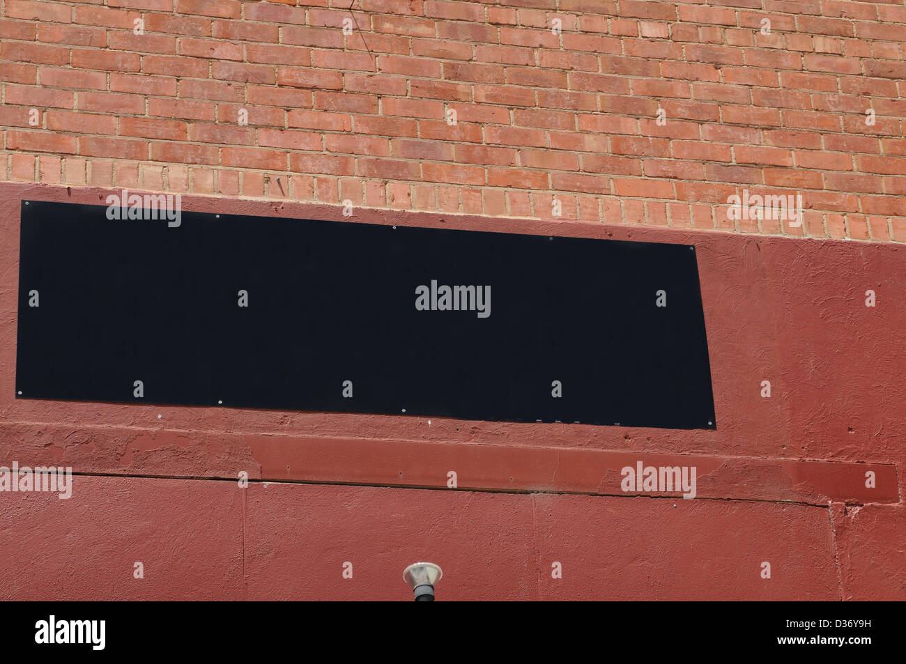 Blank black sign on the exterior of an old red brick building Stock ...