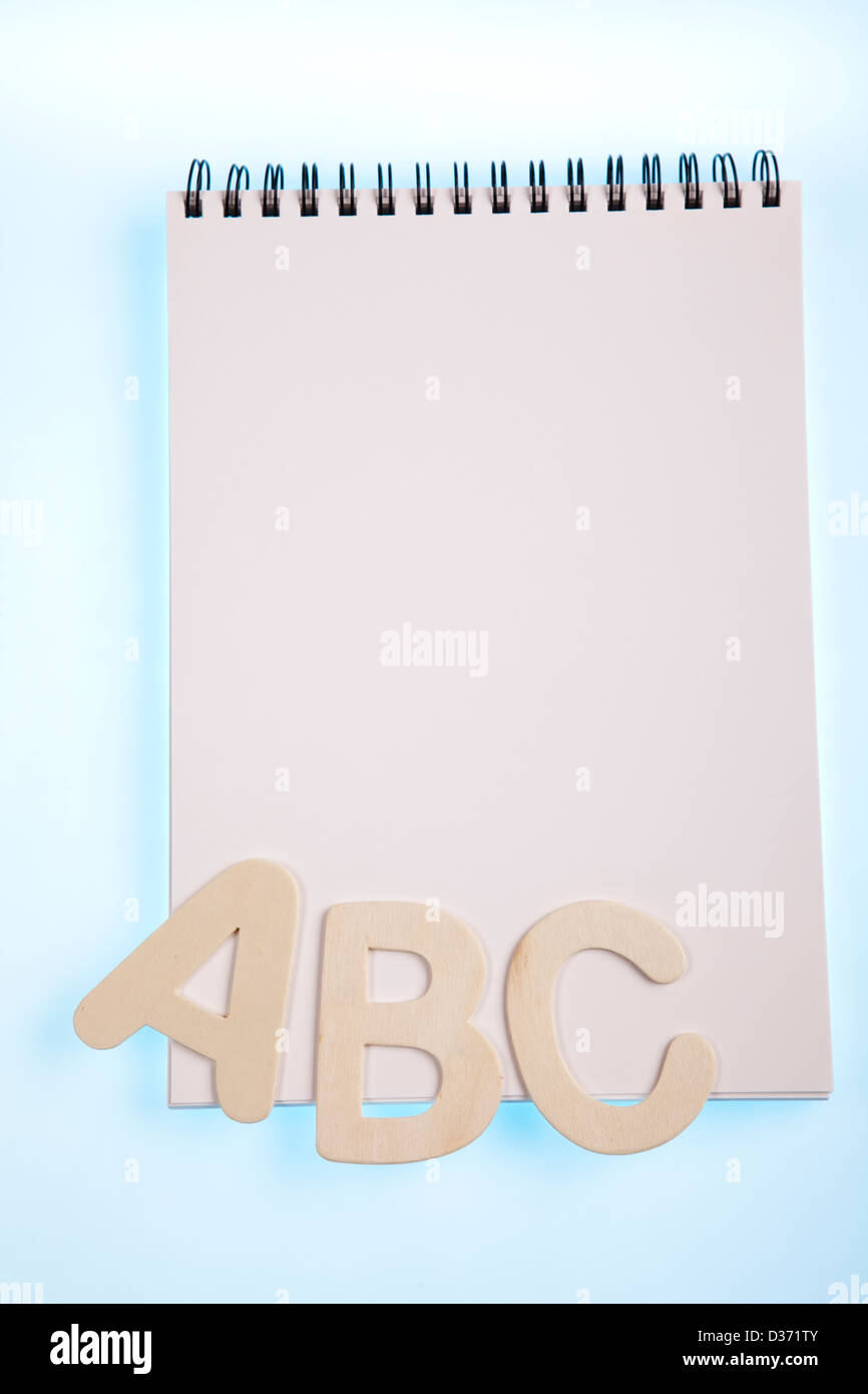 Notebook, Alphabet and school supplies Stock Photo - Alamy
