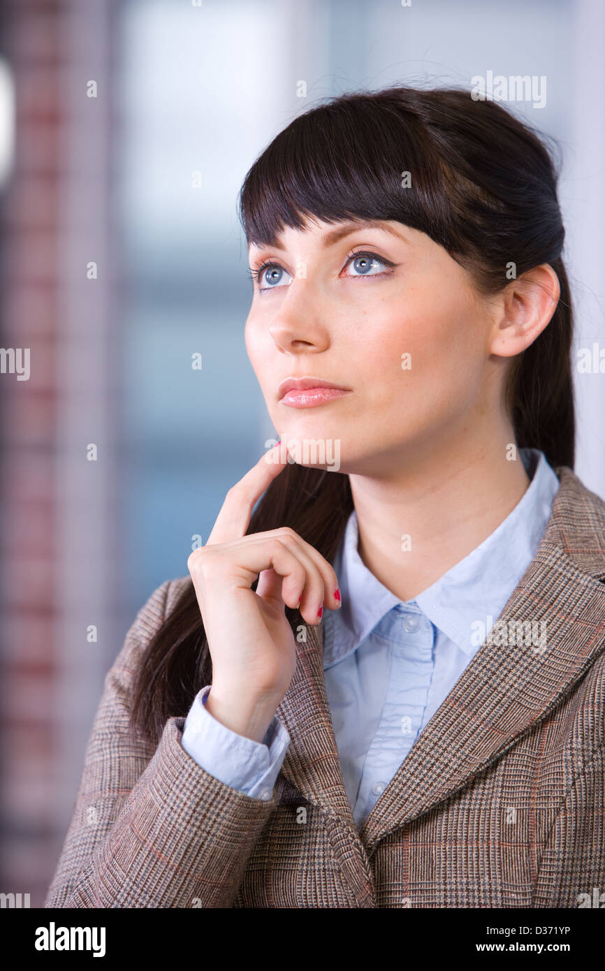 Business Woman Thinking in a Modern Office Stock Photo - Alamy