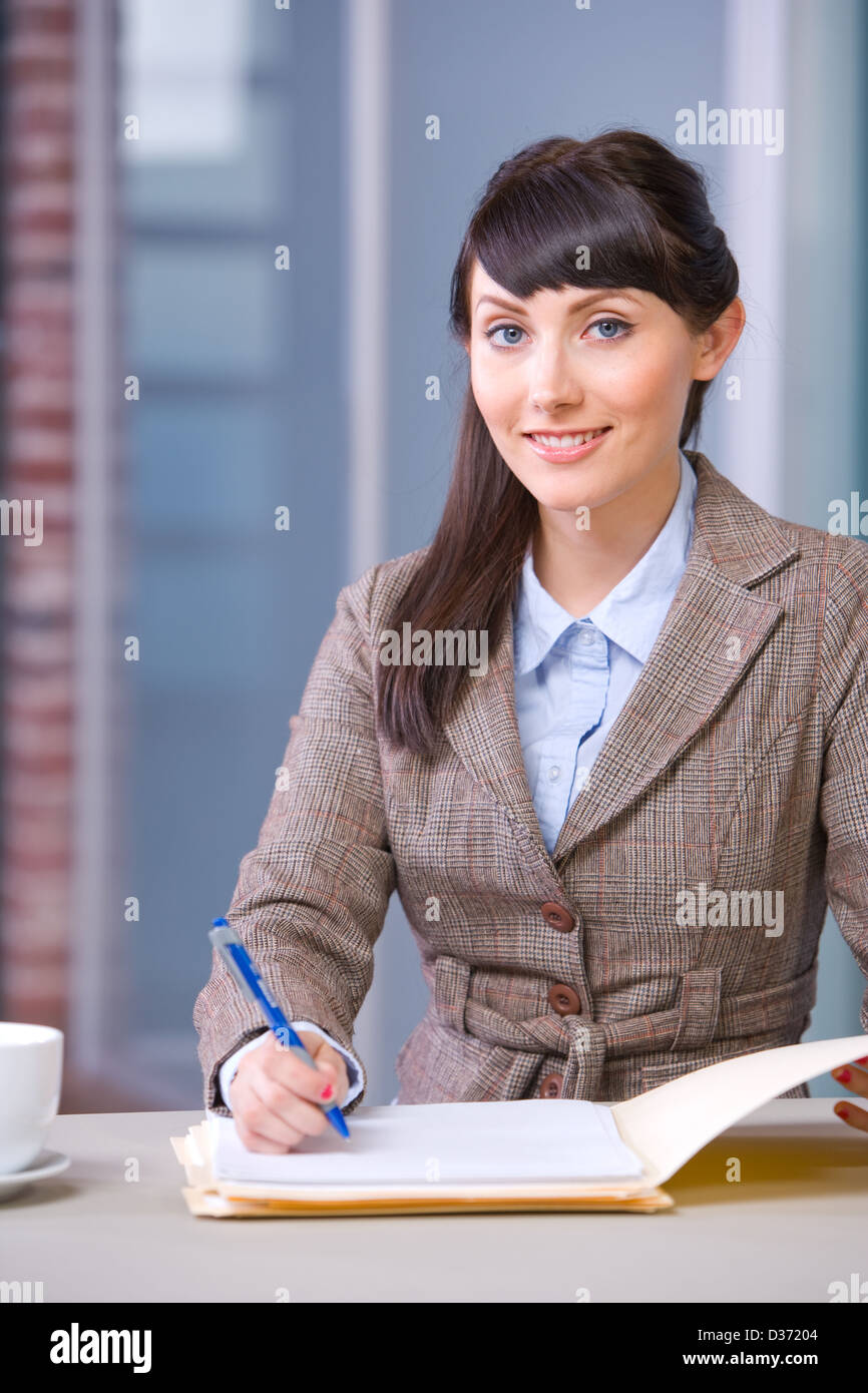 Business Woman signing documents in a modern office Stock Photo - Alamy