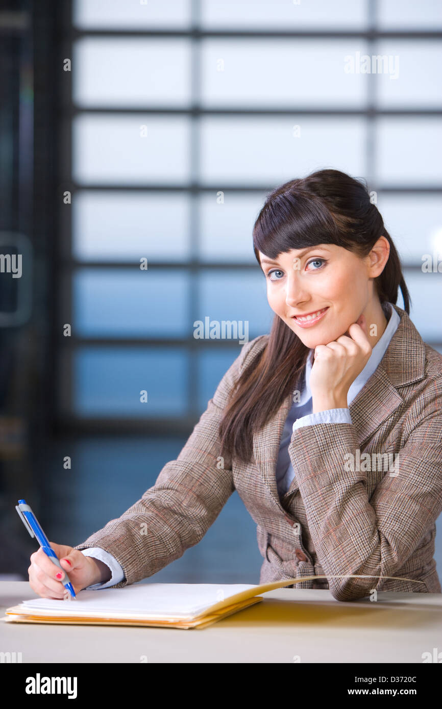 Business Woman signing documents in a modern office Stock Photo - Alamy