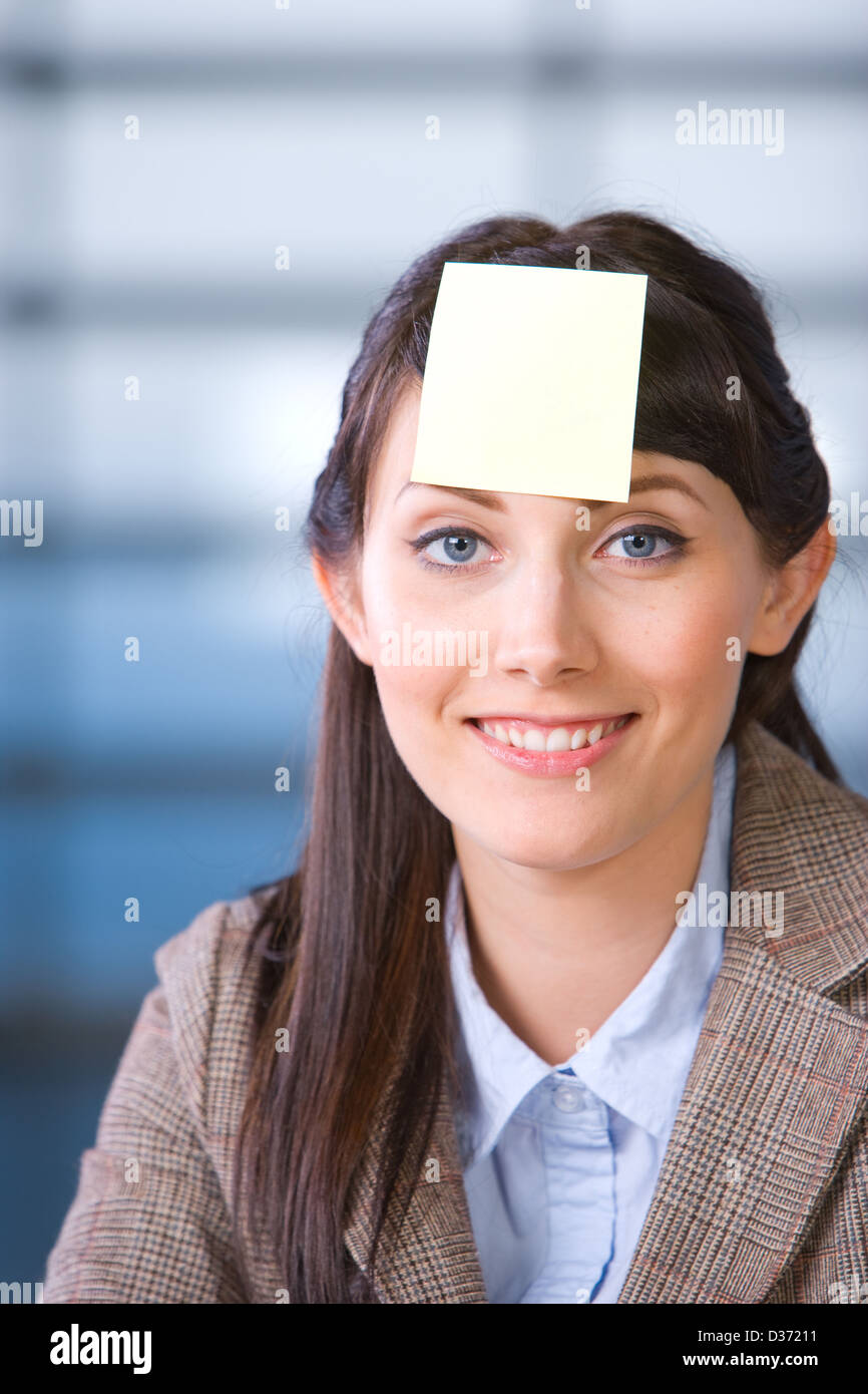 Business Woman post it on head in modern office Stock Photo - Alamy