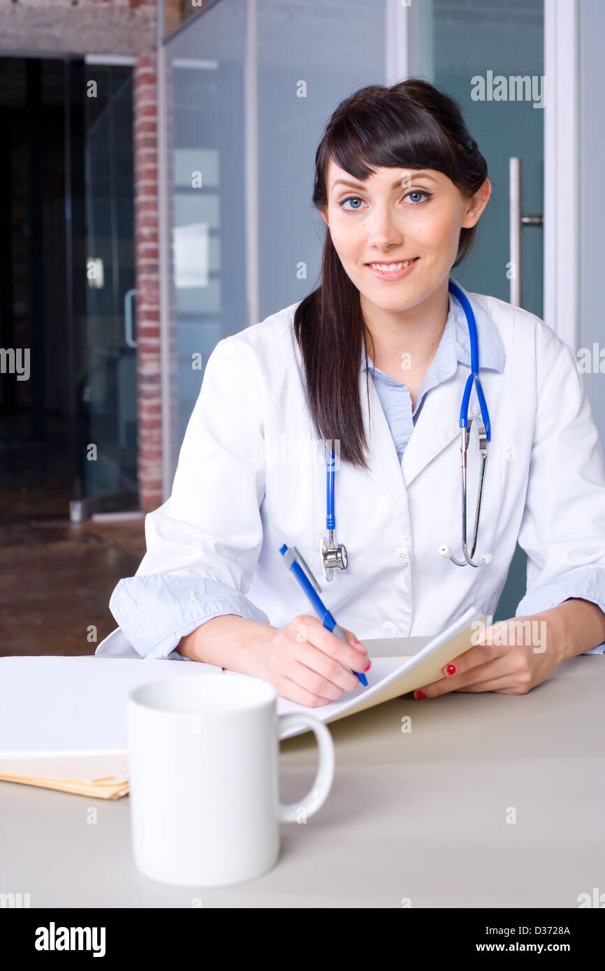 Woman doctor with chart in modern hospital Stock Photo - Alamy