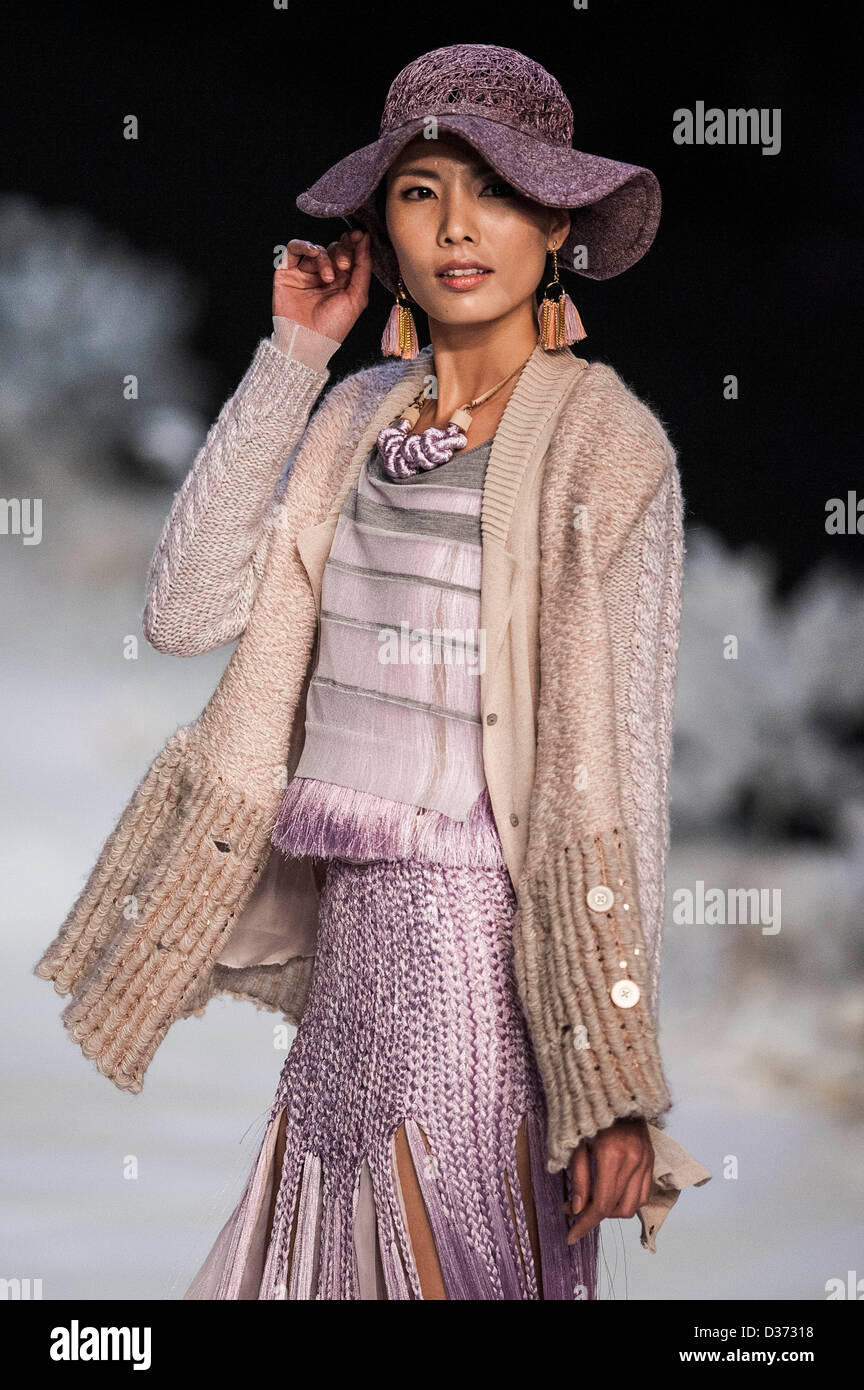 A model showcases designs on the runway by Kay Wing Yuen during day 3 ...