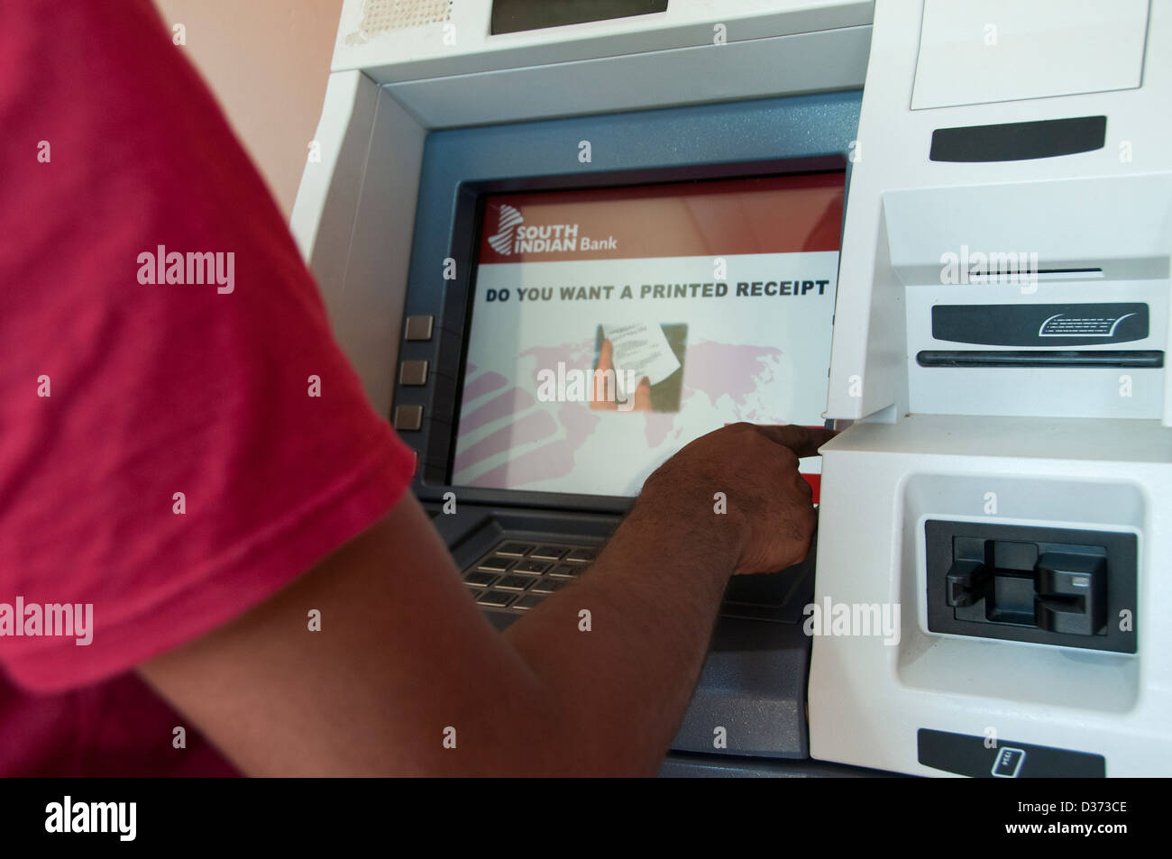 Man using ATM machine Stock Photo - Alamy