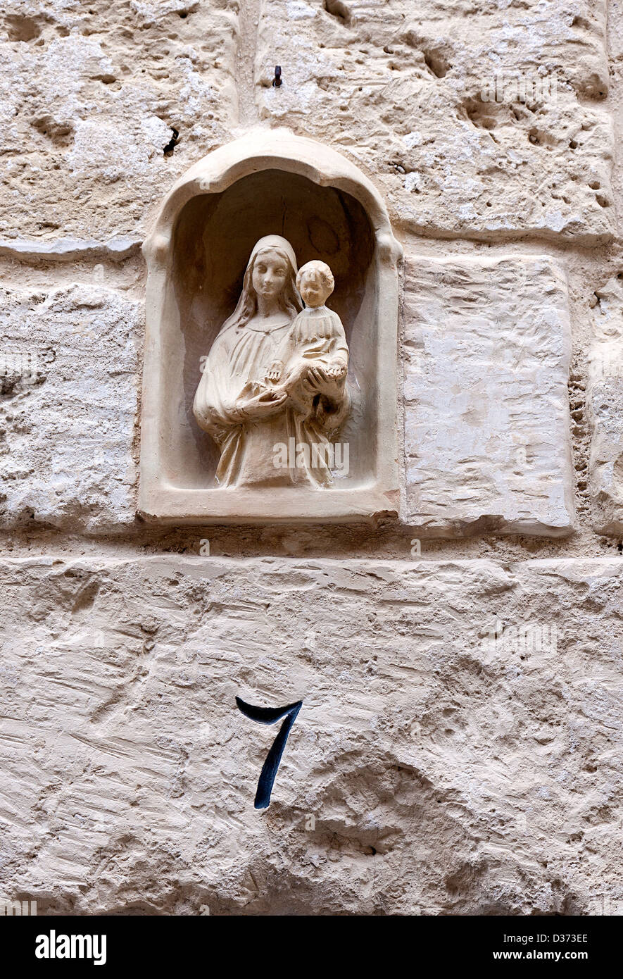 Clay wall niche with cast figures of the Virgin Mary and baby Jesus and ...