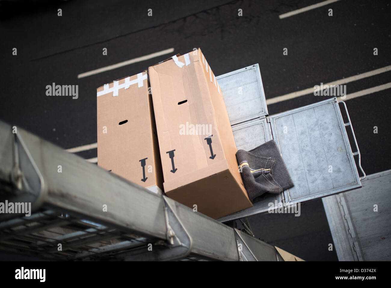 Relocation: Boxes on a lift being elevated from the moving van Stock ...