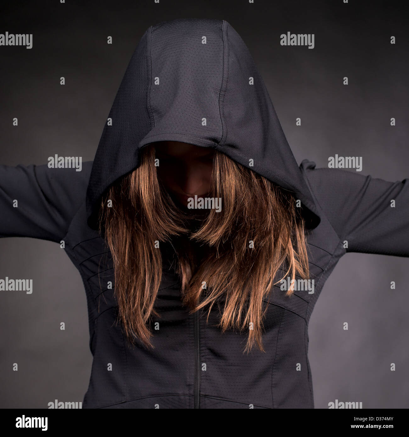 Closeup portrait of young woman in hood with hidden face Stock Photo ...