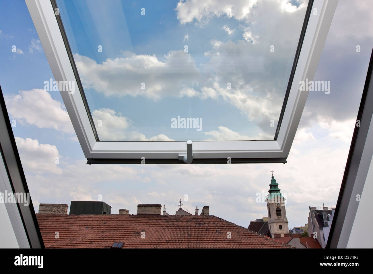 Looking through open roof-top window with urban skyline Stock Photo - Alamy